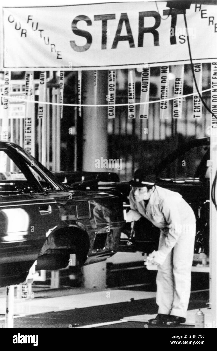 Under a sign touting the beginning of the future, a Japanese inspector ...