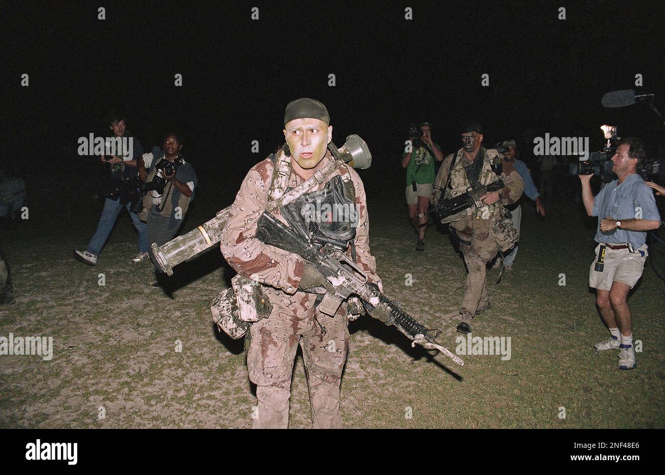 U.S. Marines are pictured running onto the beach while being pursued by ...