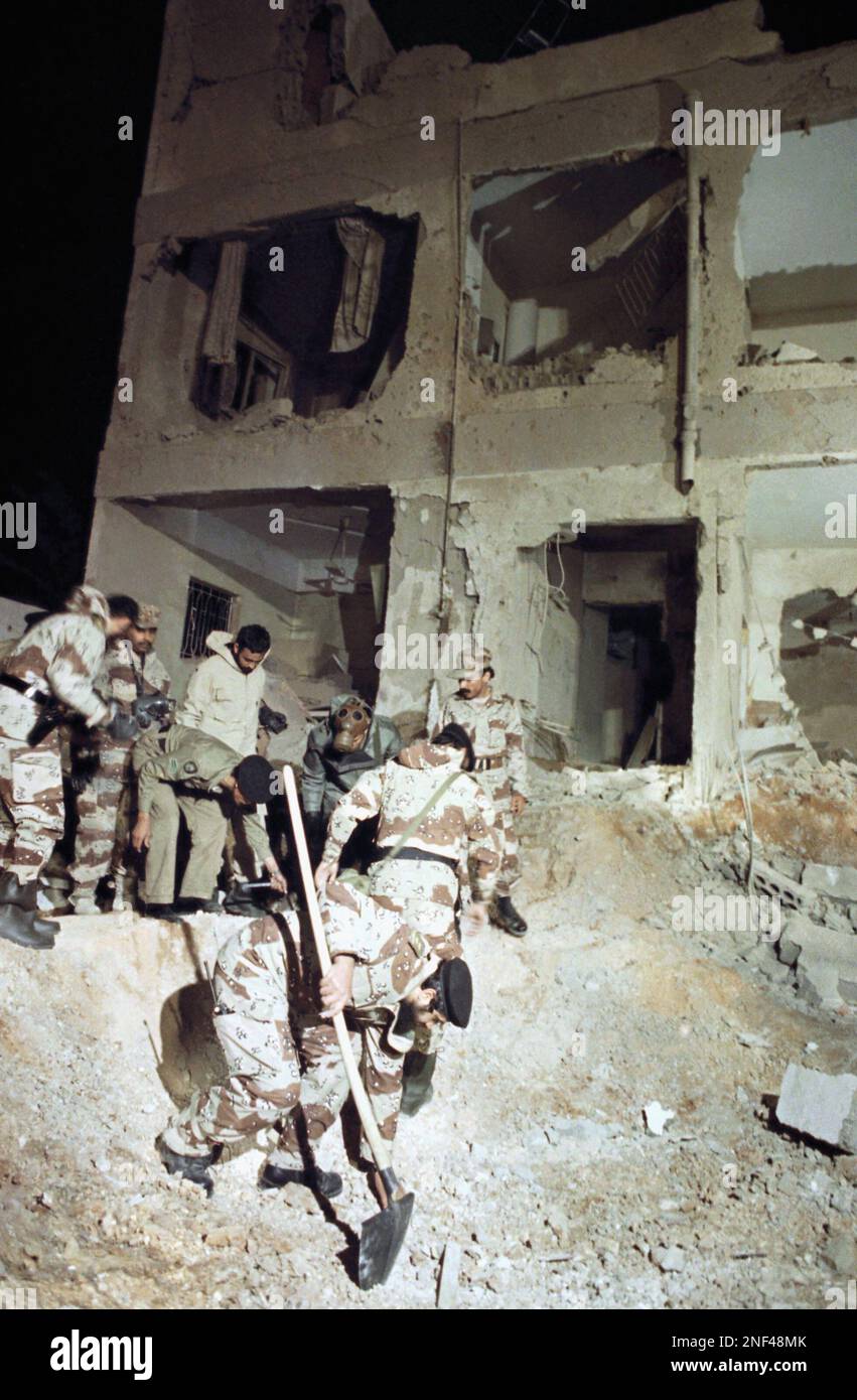 Soldiers look for missile remains after a U.S. Patriot interception of ...