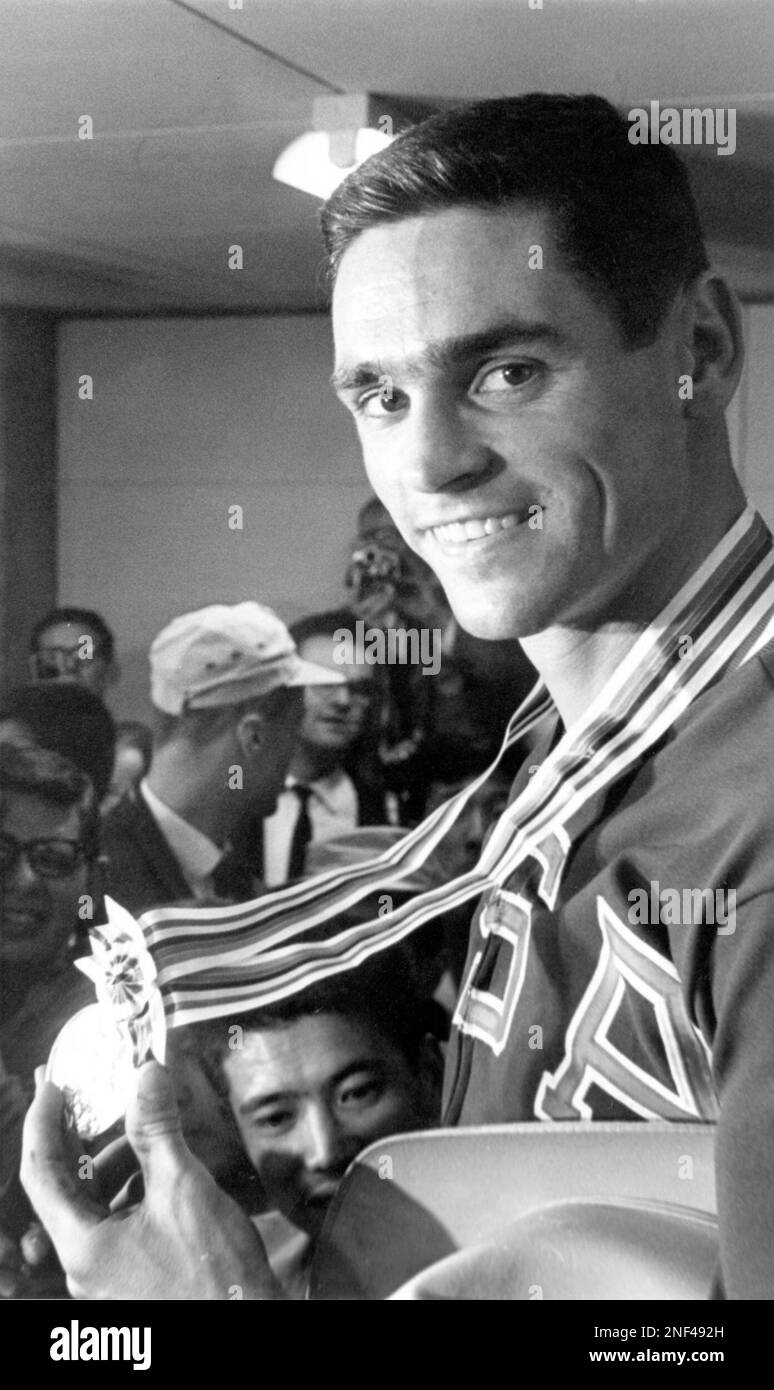 U.S.A.'s Fred Hansen smiling with his gold medal he won in Olympic Pole Vault event, Oct. 18 ...