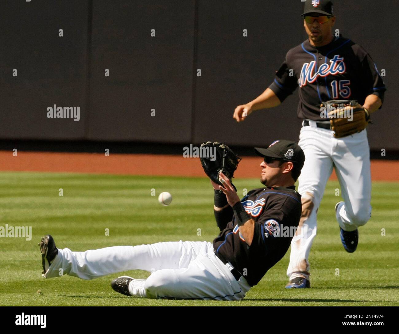 New York Mets right fielder Ryan Church slides while fielding a line ...