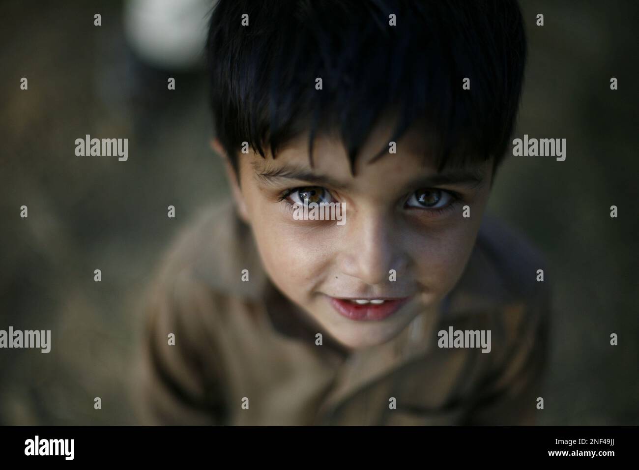 A Pakistani boy is seen at a refugee camp in Mardan, in northwest ...