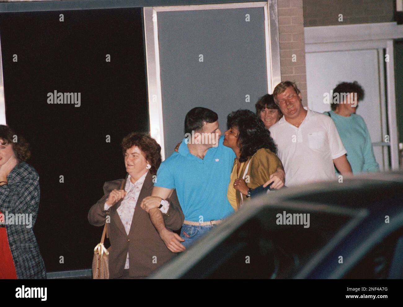 A man identified as Mark Ward of Middletown, N.J., kisses his fiancée ...
