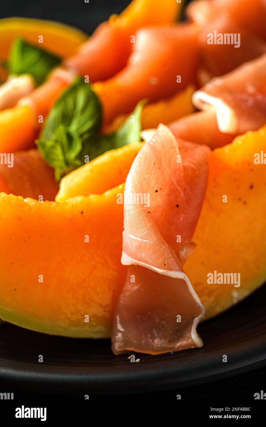 melon with parma on a dark background. High quality photo Stock Photo ...