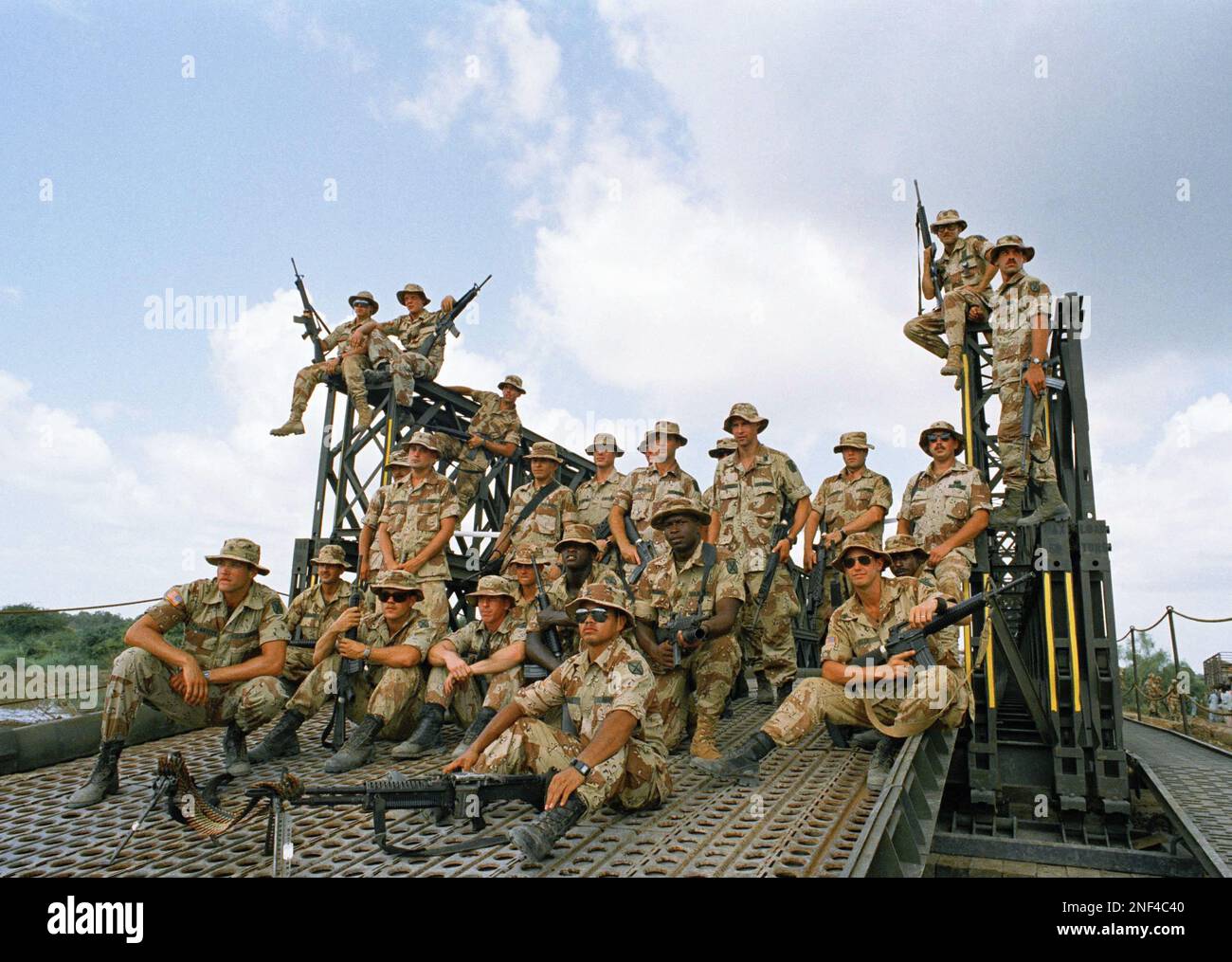 U.S. Army engineers sit atop the "Bailey Bridge" they erected near ...