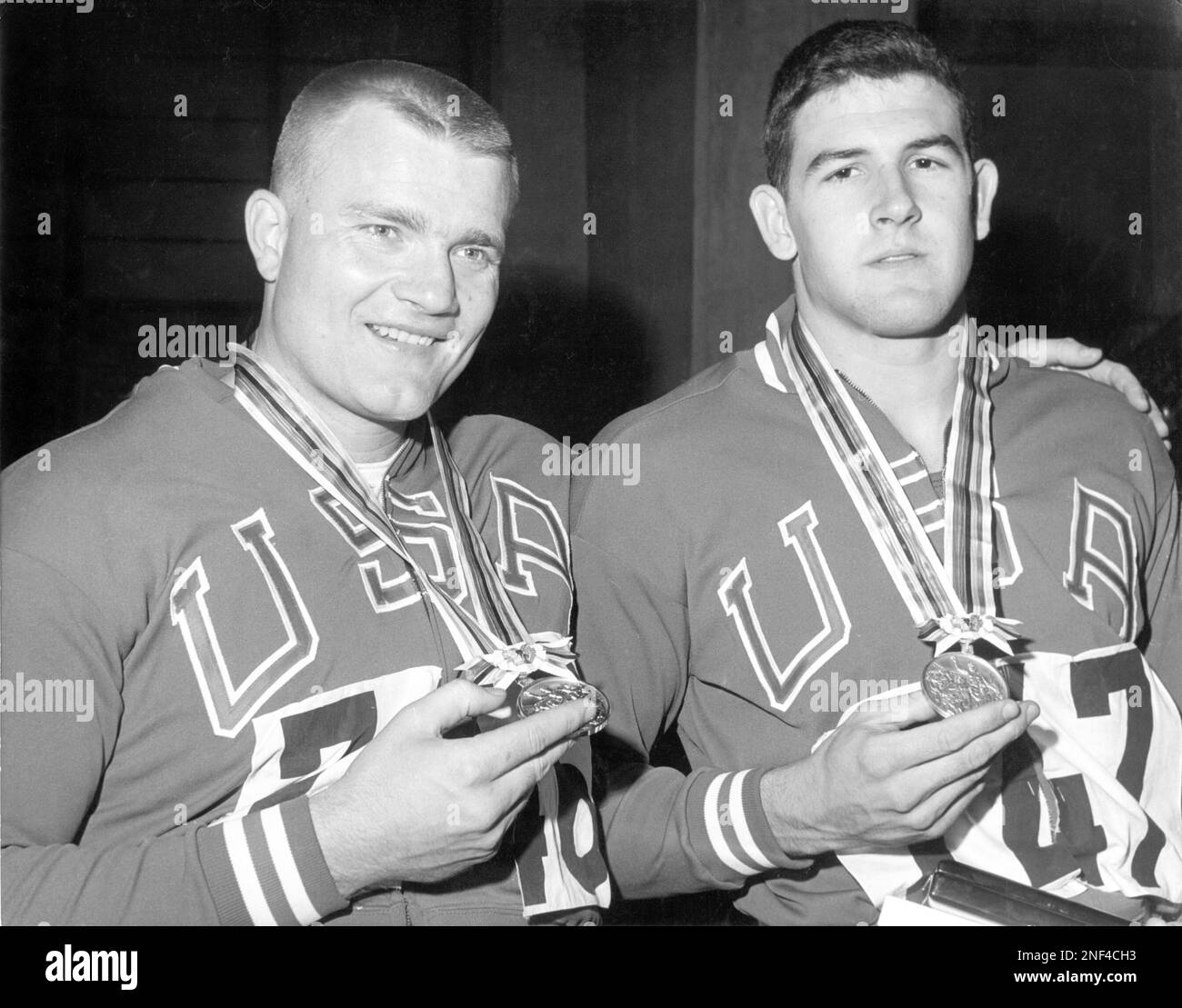 Americans Dallas Long, left, and James Matson display their gold and silver medals they won in ...