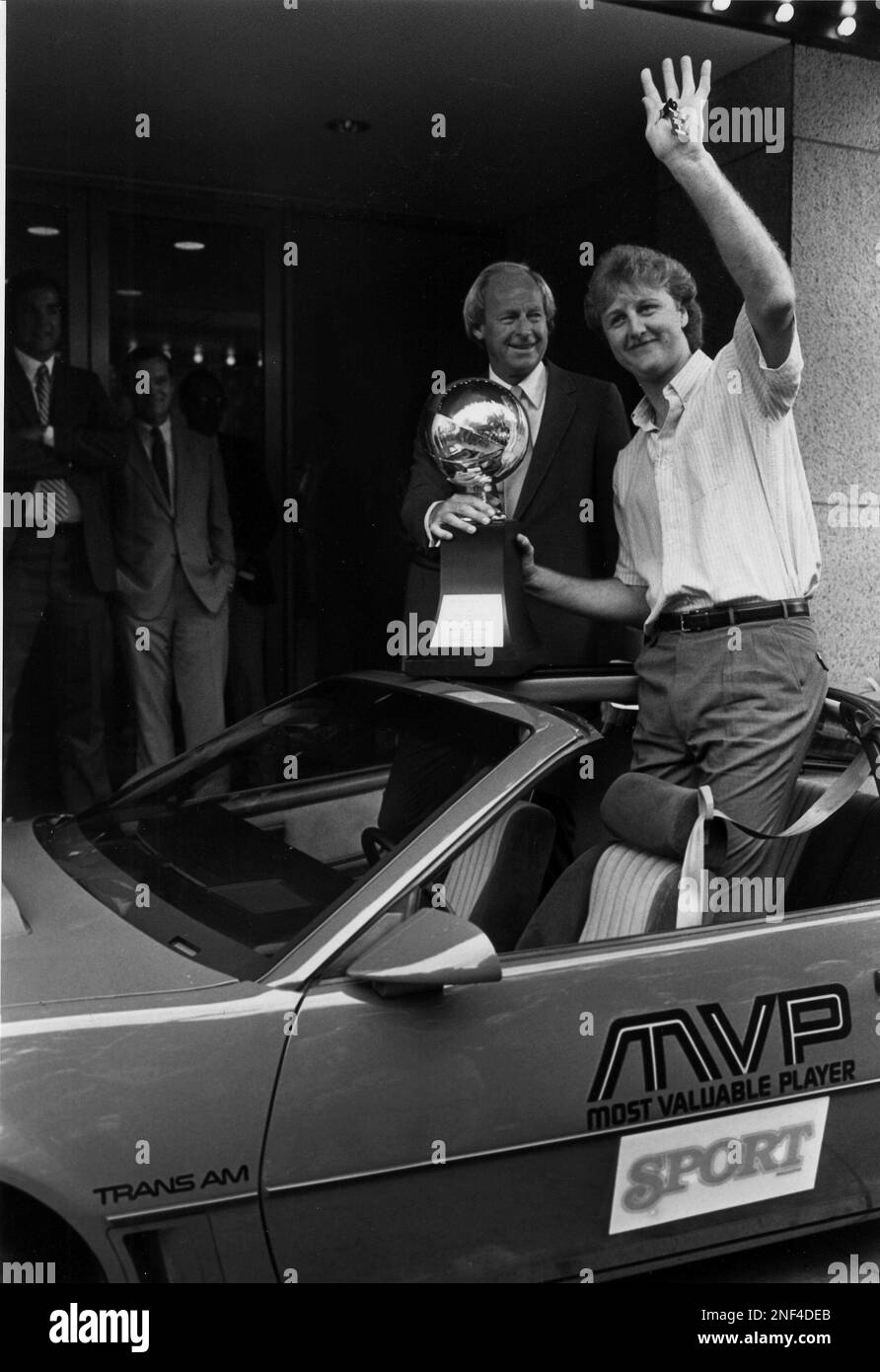 Larry Bird of the Boston Celtics waves the keys to his new Trans-Am car ...