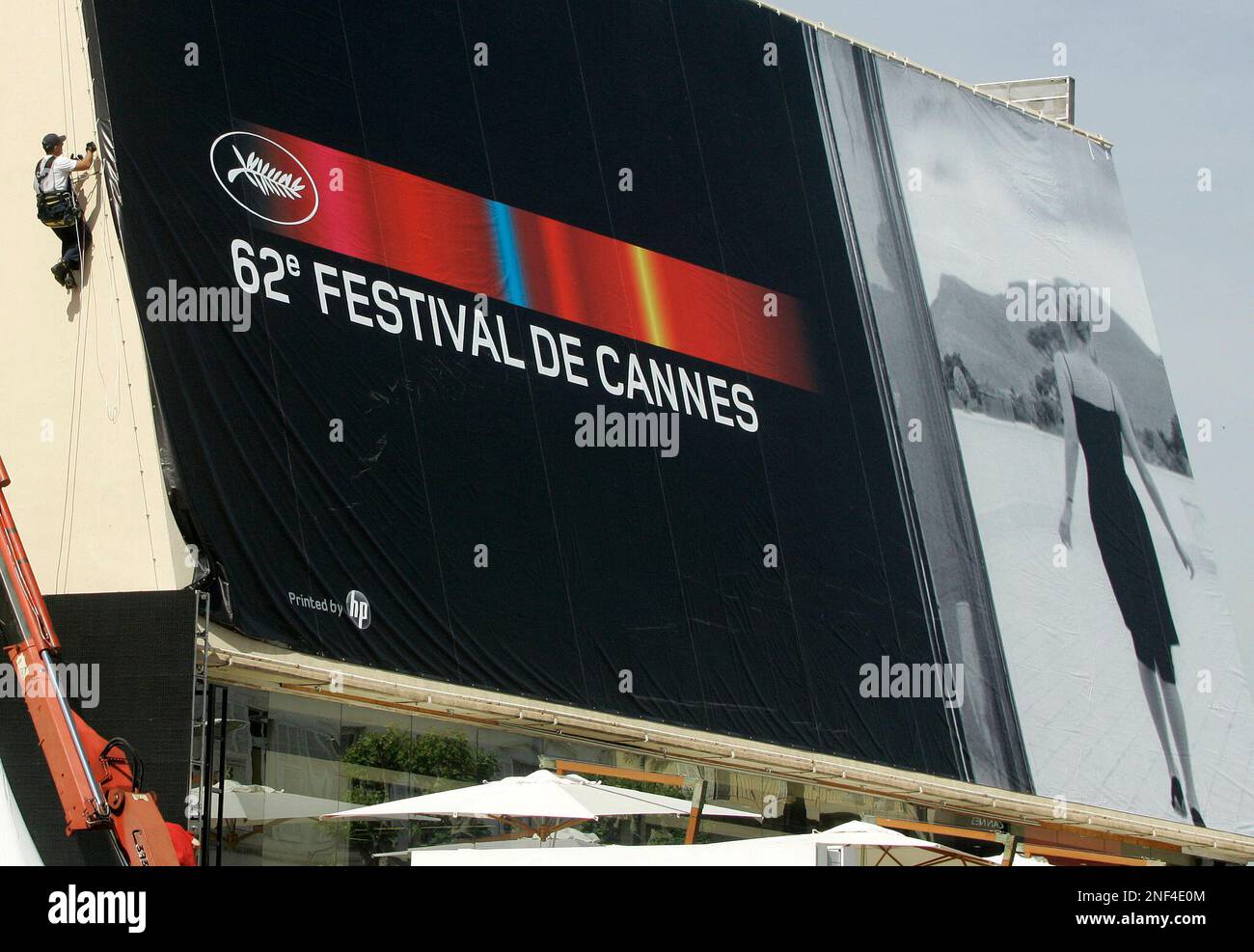 A worker sets up a giant canvas of the 62st Cannes Film Festival's ...
