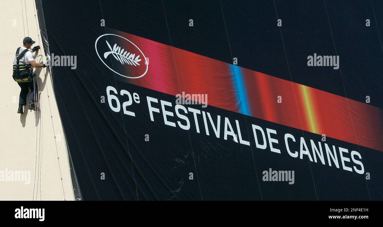 A worker sets up a giant canvas of the 62st Cannes Film Festival's ...