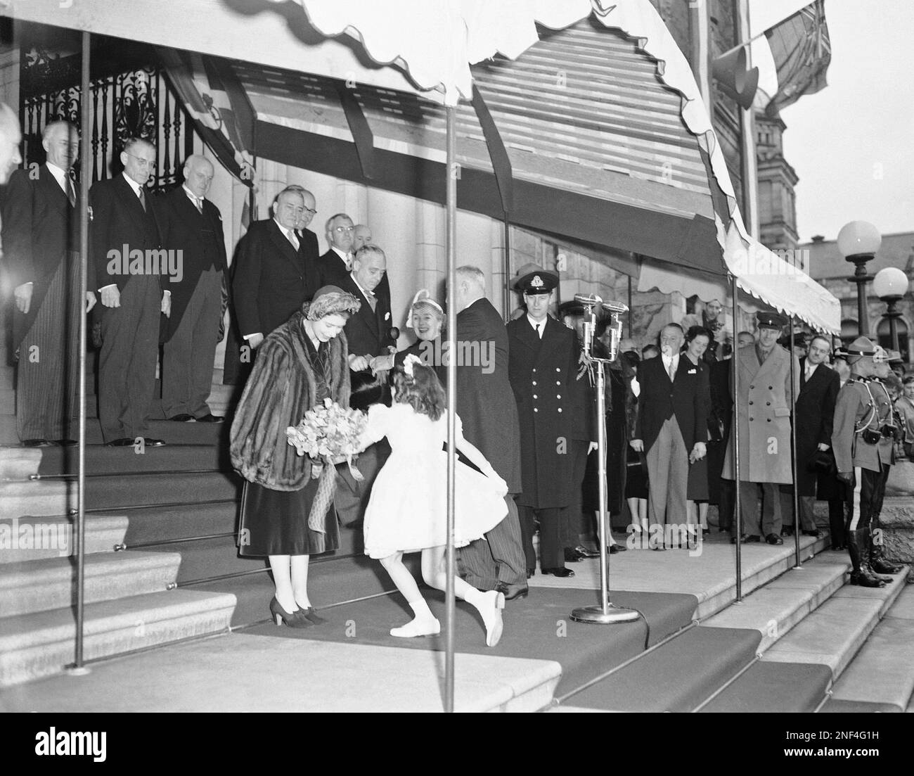 Miss Connie Cownden of Victoria, British Columbia, curtsies as she ...