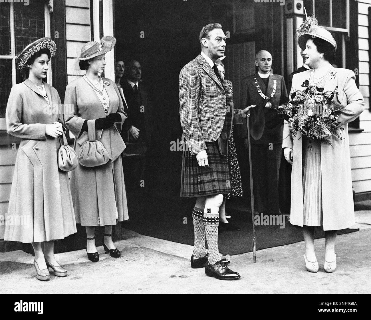 Dressed in kilts, King George VI, waits with Queen Elizabeth (right ...