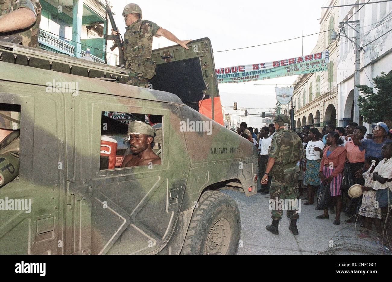 A Haitian soldier is driven away by U.S. Army soldiers after he was ...