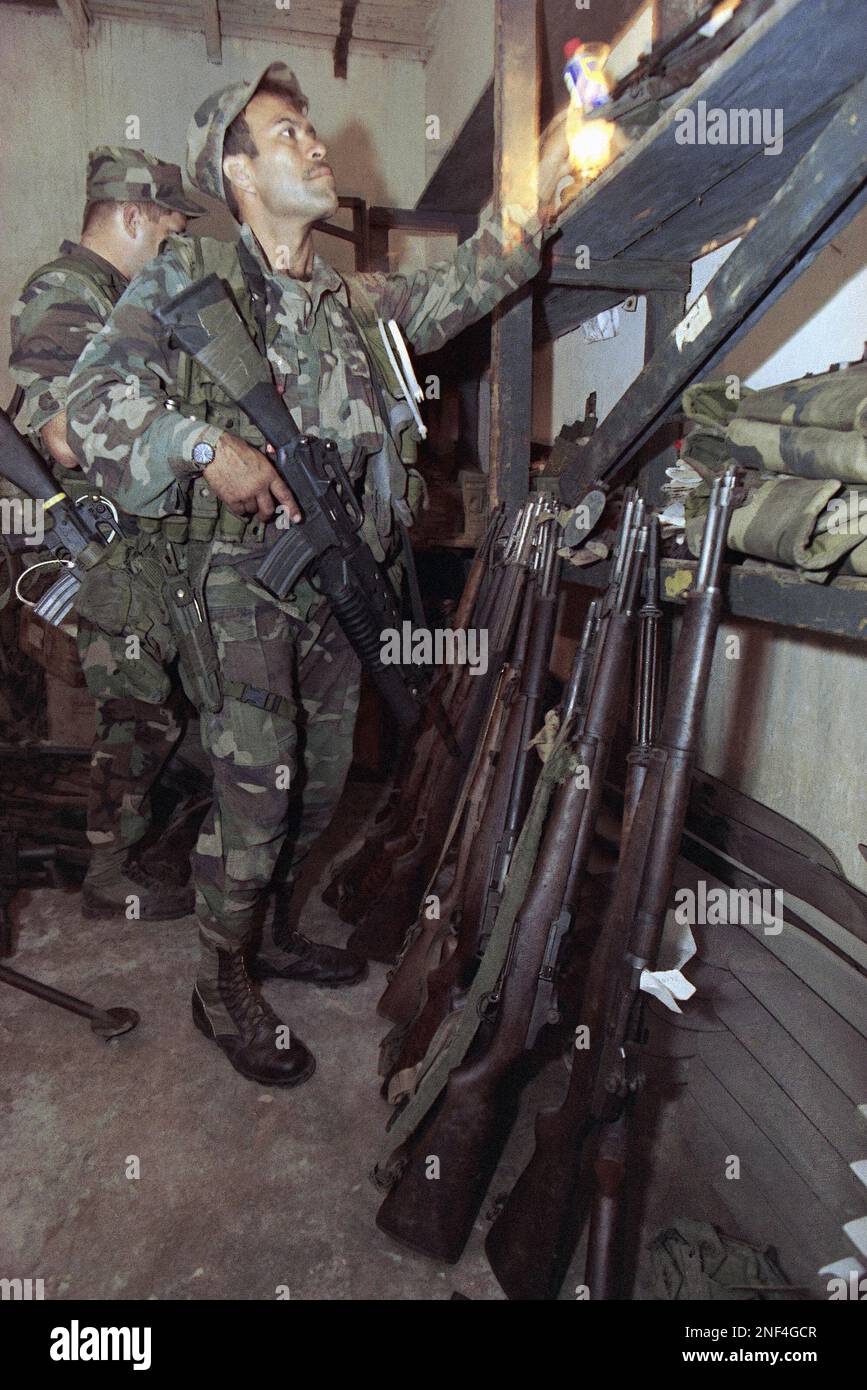 Members of the U.S. Special Forces using lamps, search through weapons ...