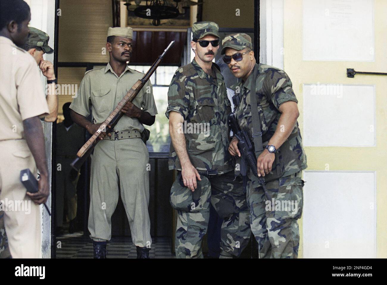 U.S. soldiers talk while standing in front of a Haitian military ...