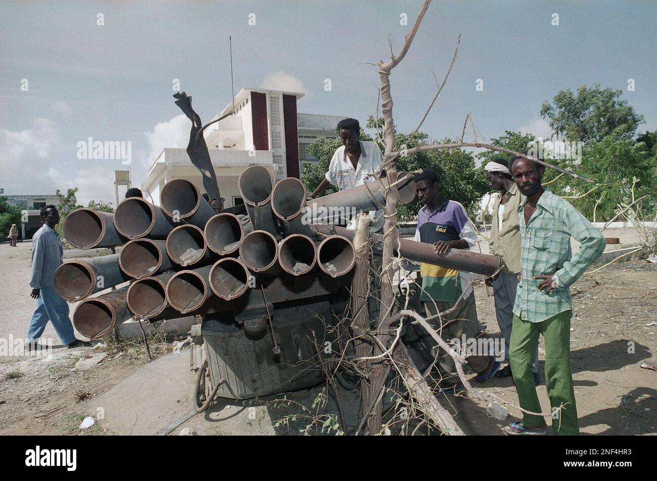 Somalis inspect the remains of a multiple rocket-launcher that was ...
