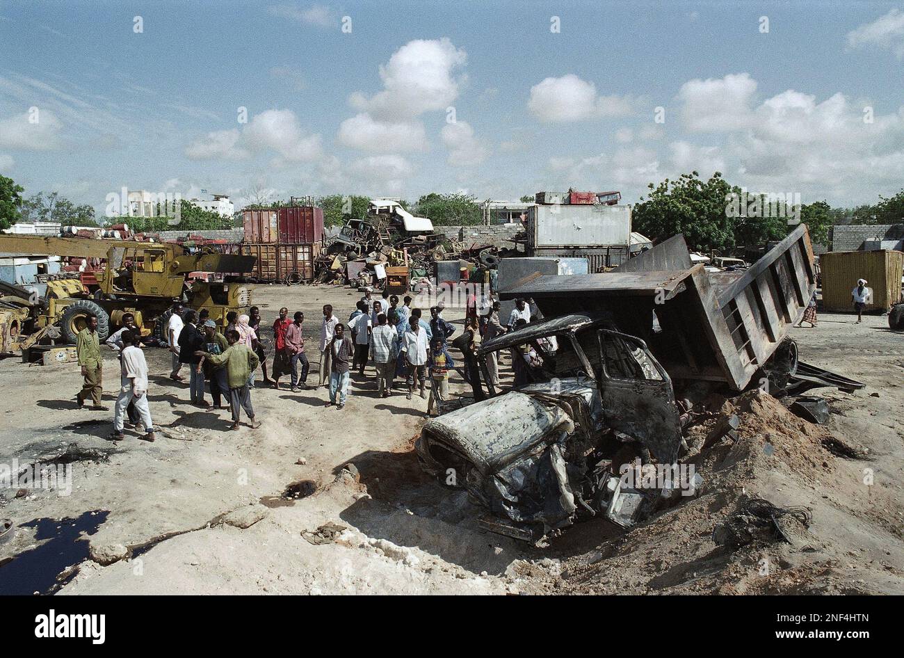 Somalis view the damage along the streets of Mogadishu on Sunday, June ...