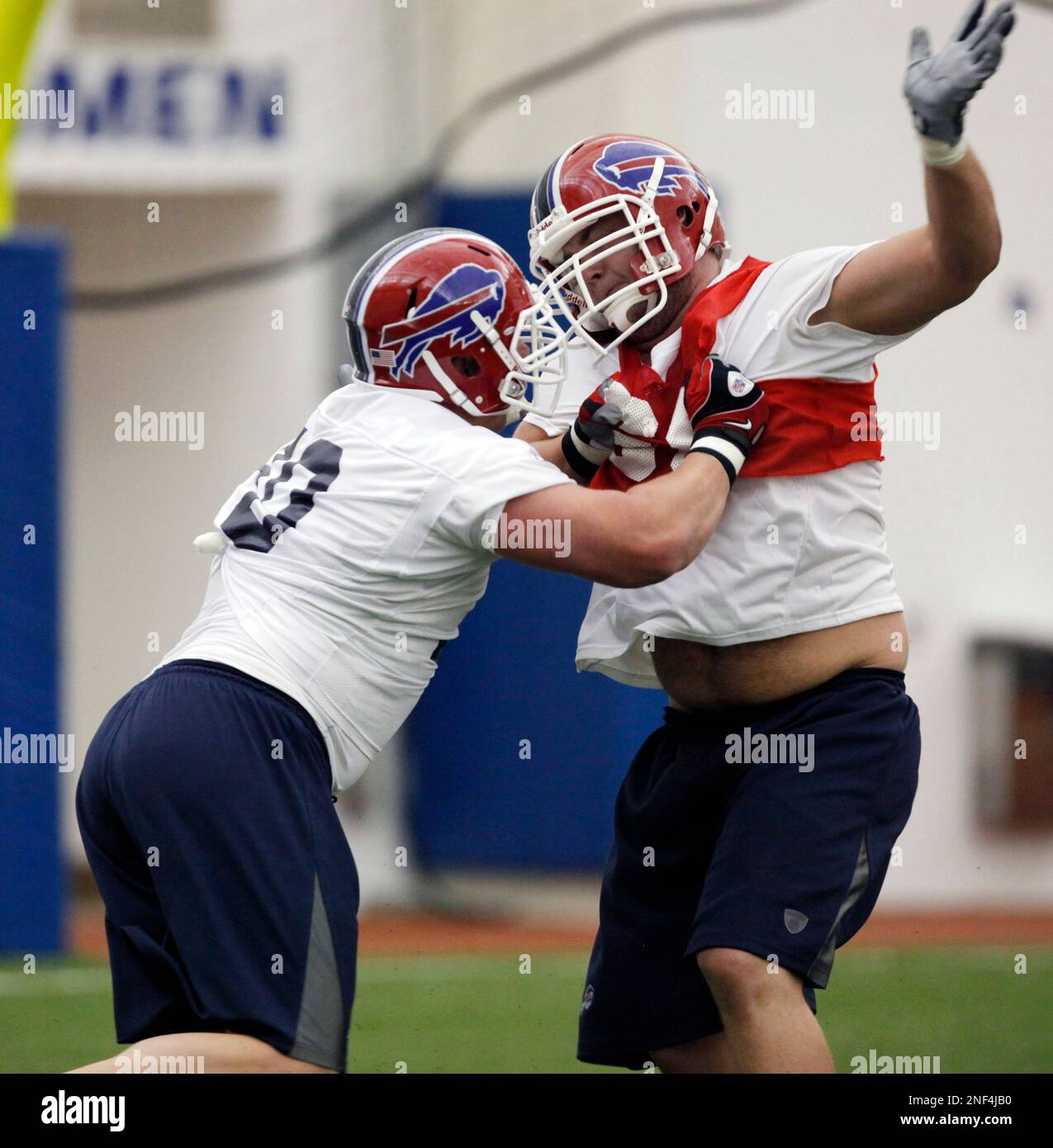 Buffalo Bills' Eric Wood (70) runs a drill with Joe Longacre (66 ...