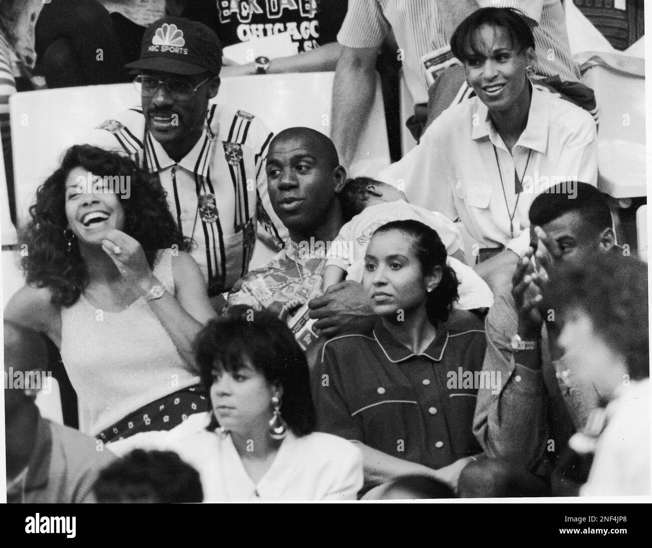 Earvin Johnson, center, his wife Cookie and baby Earvin Johnson III ...