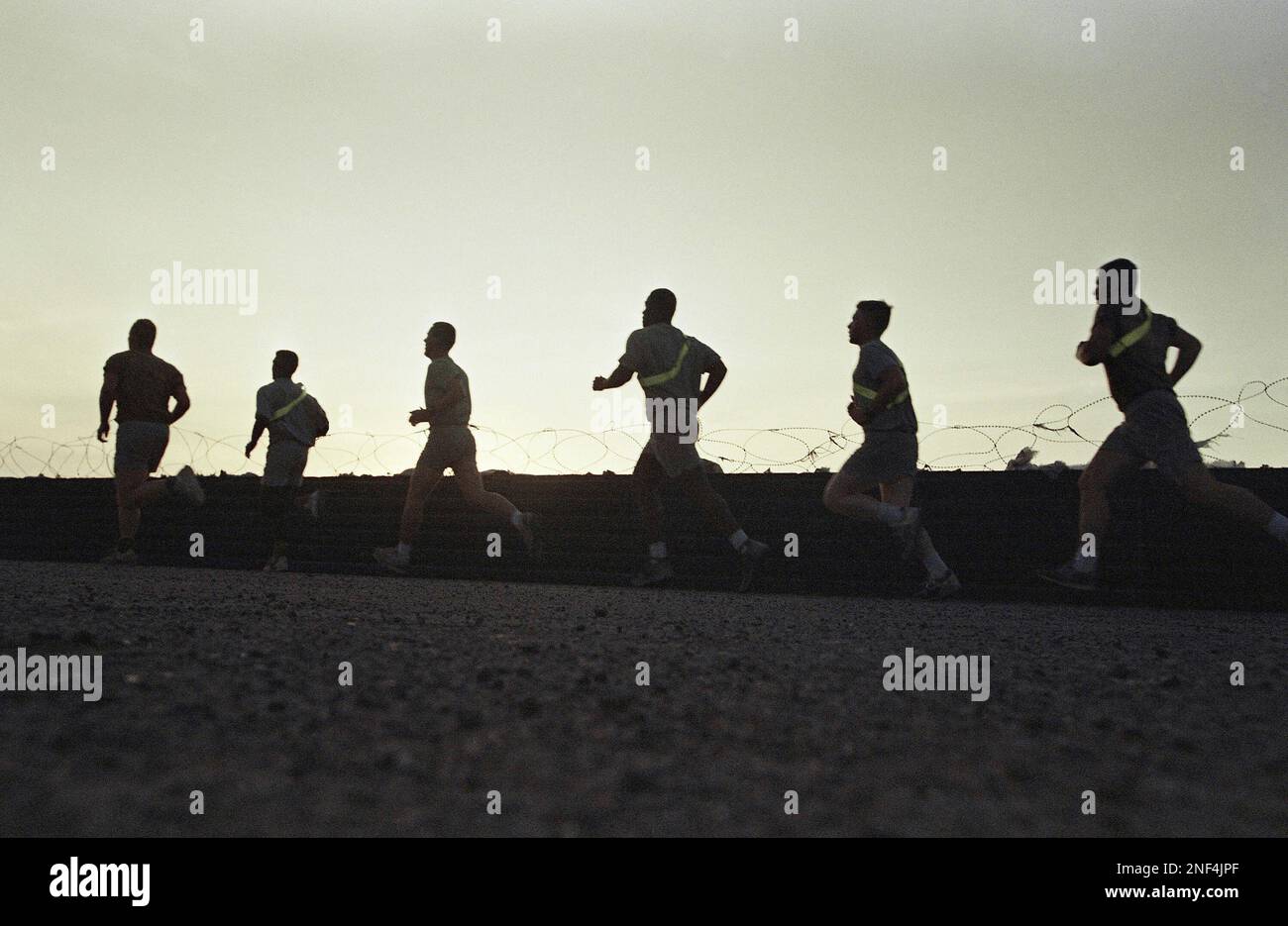 American army soldiers take a sunrise run garrisoned in their barbed ...