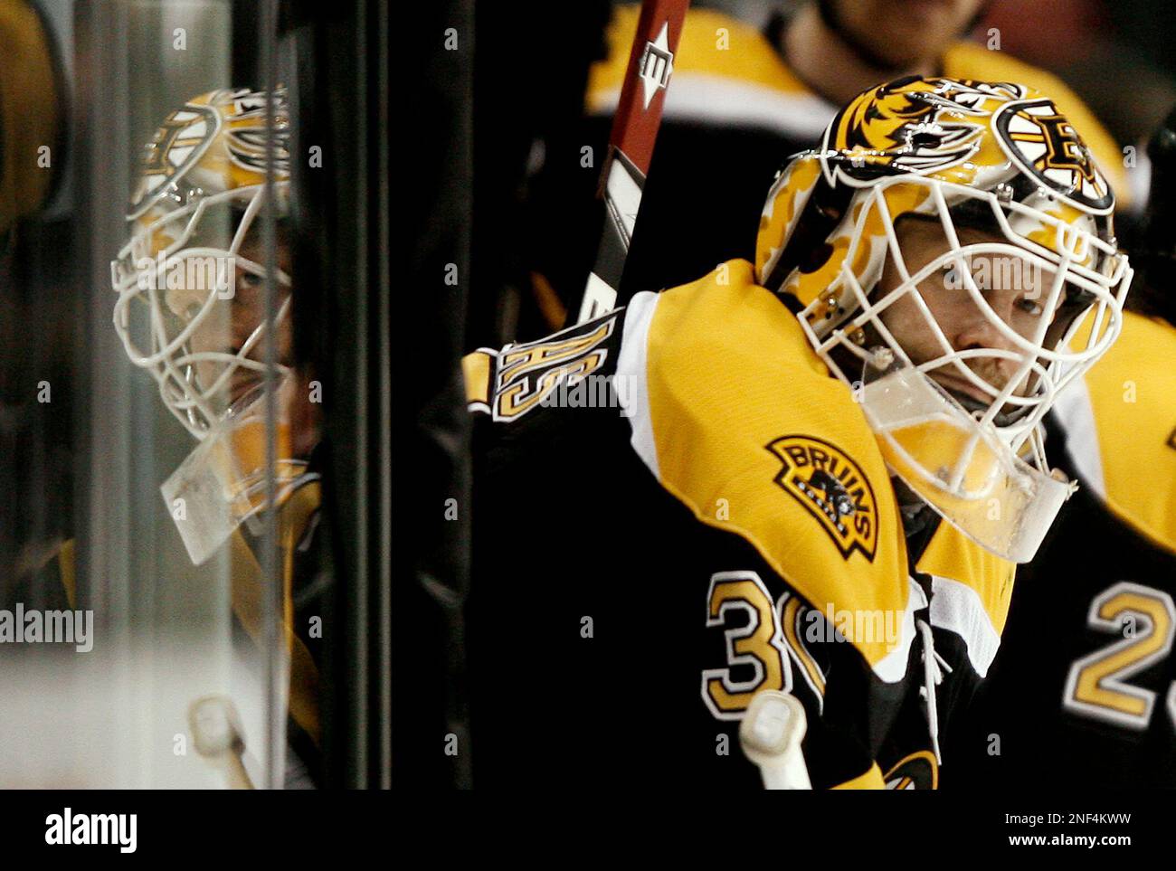 Boston Bruins goaltender Tim Thomas looks on from the bench during the ...