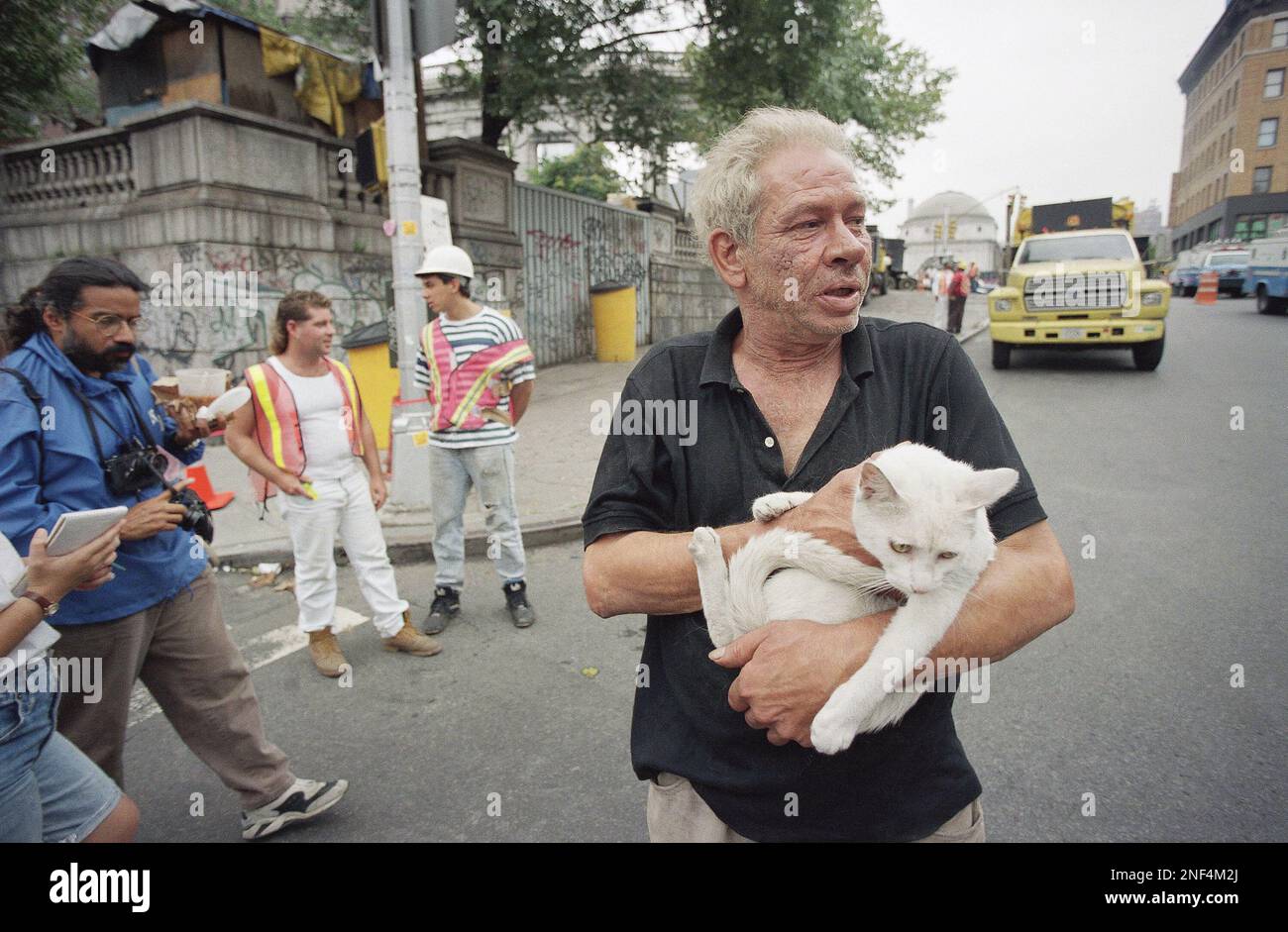 Louis Watson clutches his cat "Thomas" after rescuing him from a ...
