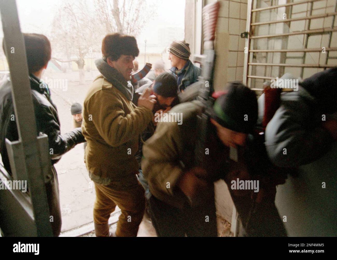 Chechen fighters and civilians crowd into a building as a Russian ...