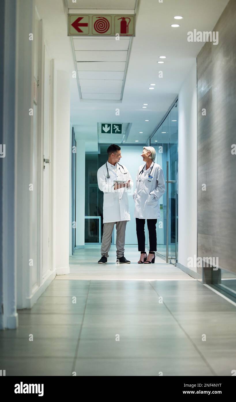 Doctor, hospital corridor and healthcare workers in a medic ...