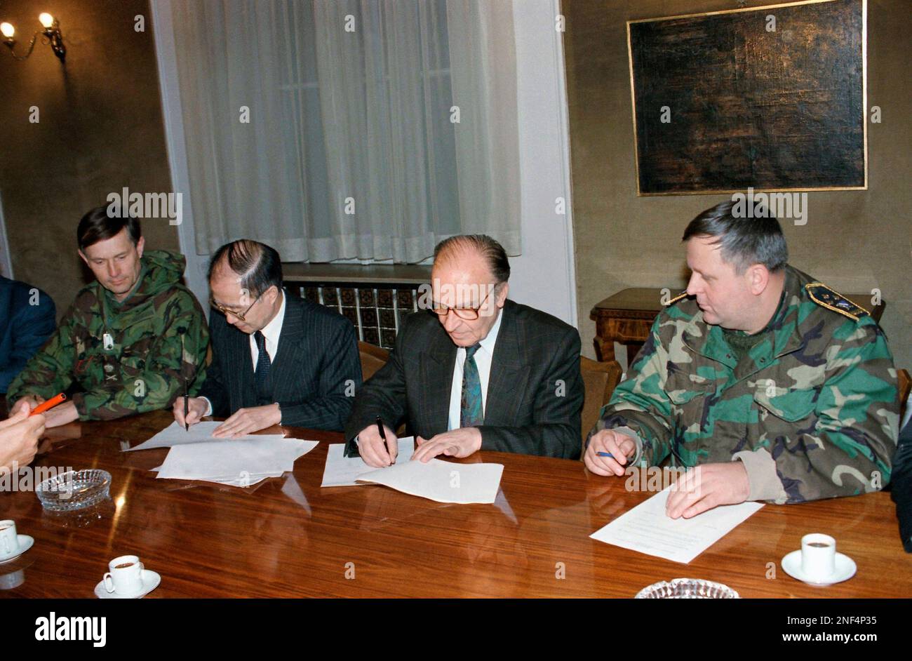 U.N. and Bosnian government representatives signing the four-month ...