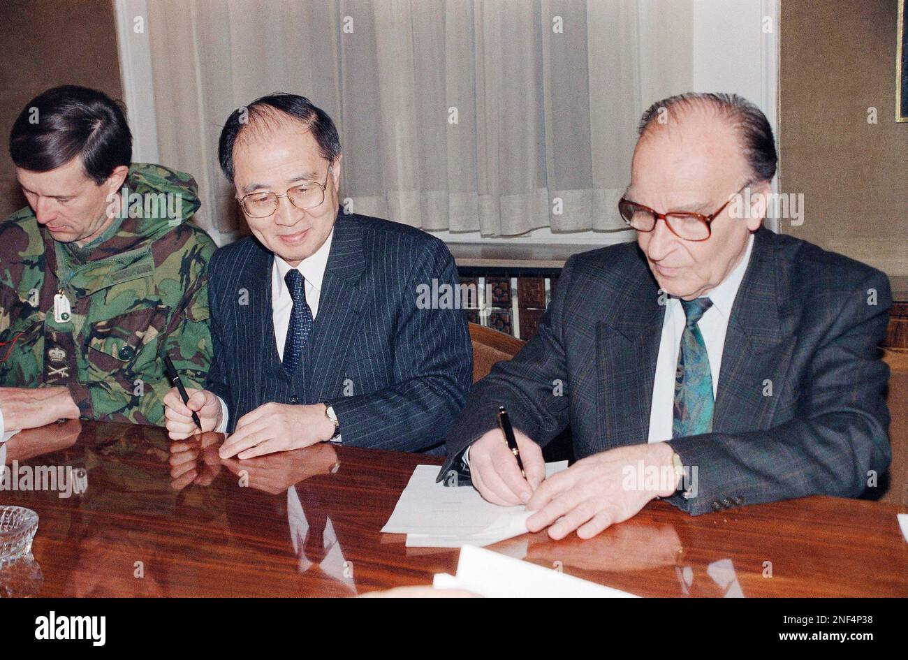 U.N. chief negotiator Yasushi Akashi, left, looks on as Bosnian ...