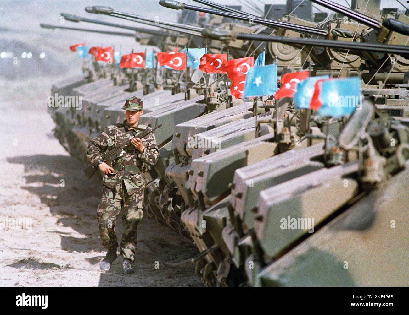 A Turkish soldier guards a line of his country’s armored vehicles at ...