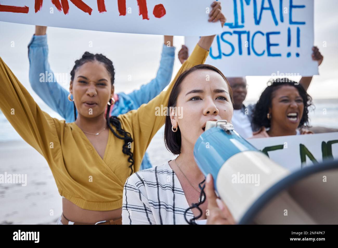 Climate change protest, megaphone and Asian woman with crowd at beach ...