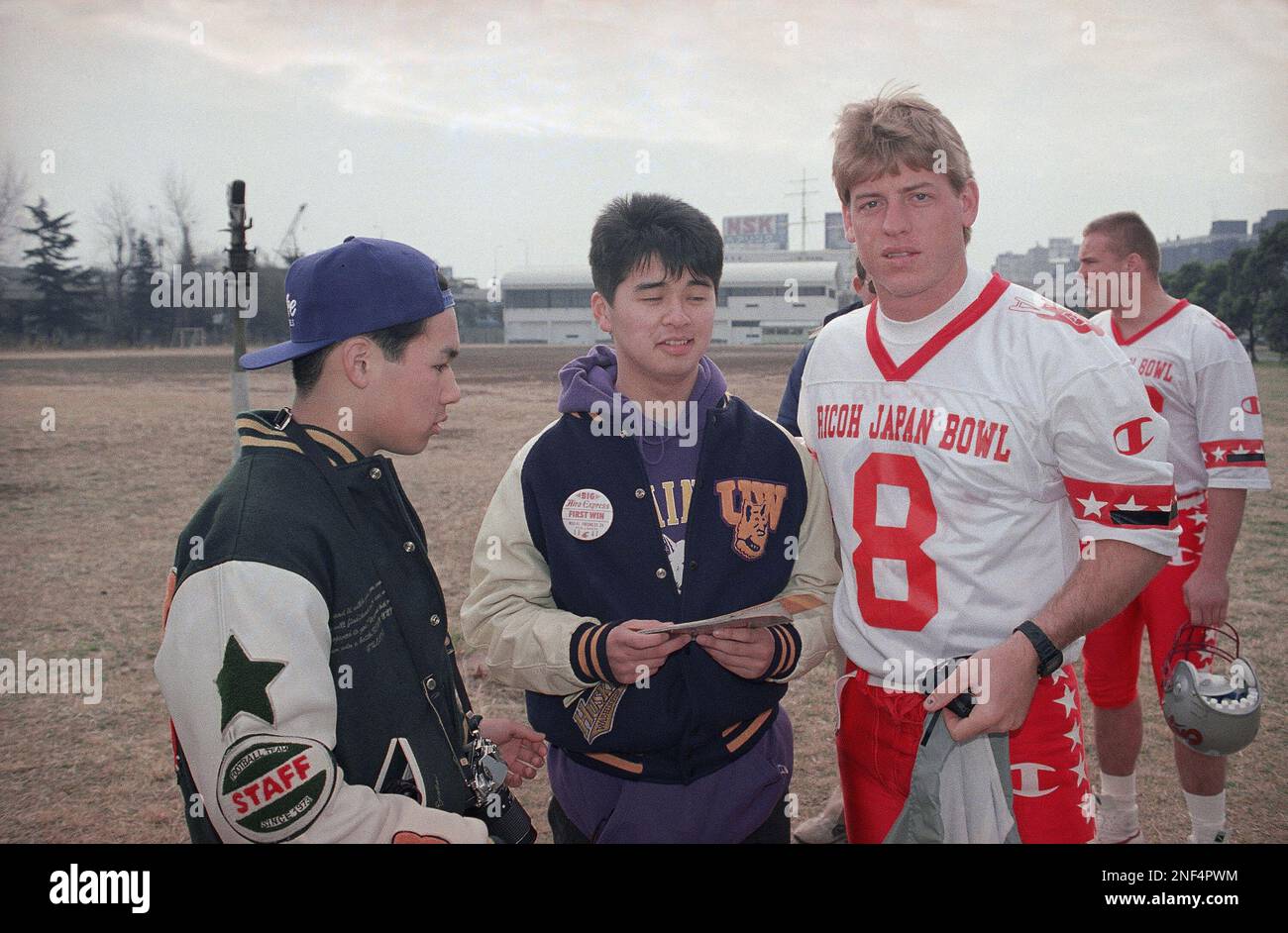 UCLA quarterback, Troy Aikman, left, poses for a snapshot with two ...