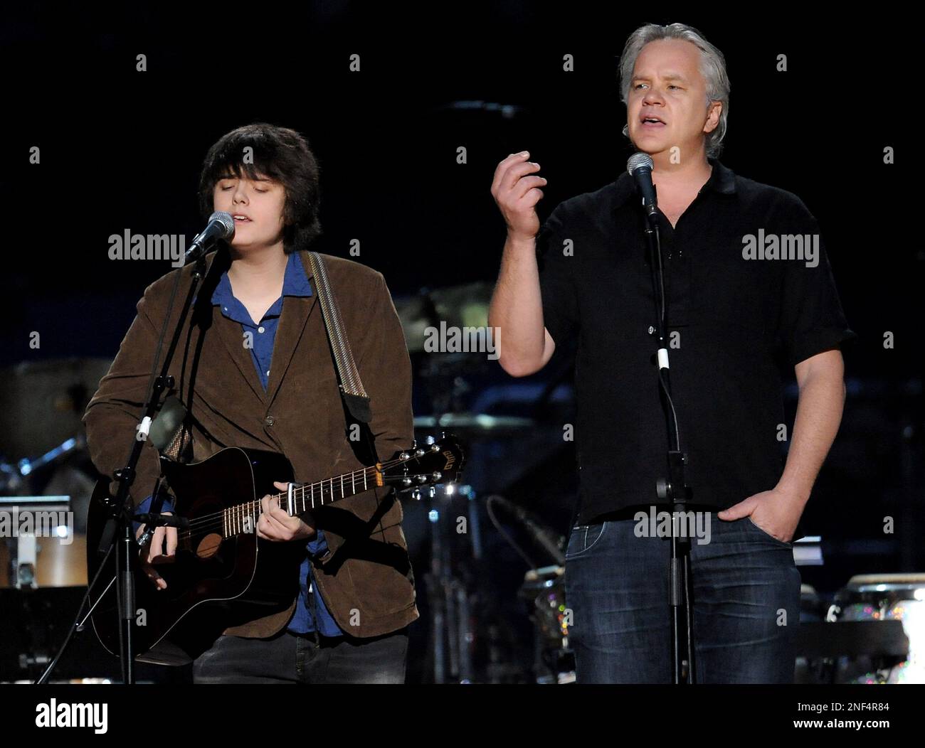 Actor Tim Robbins, right, and son Miles Robbins perform at a benefit ...