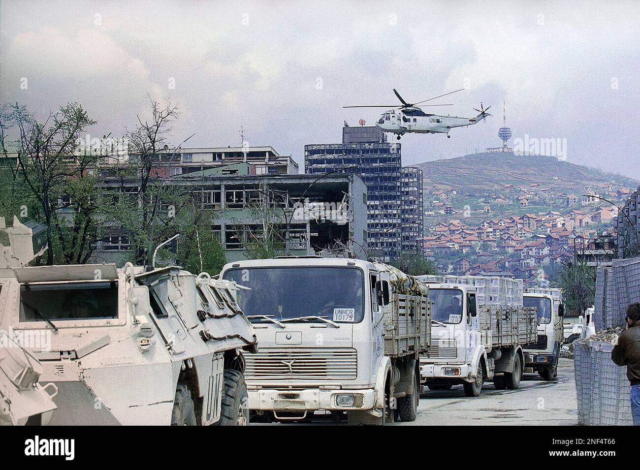 A convoy of UNHCR trucks carrying humanitarian aid, waits on the ...