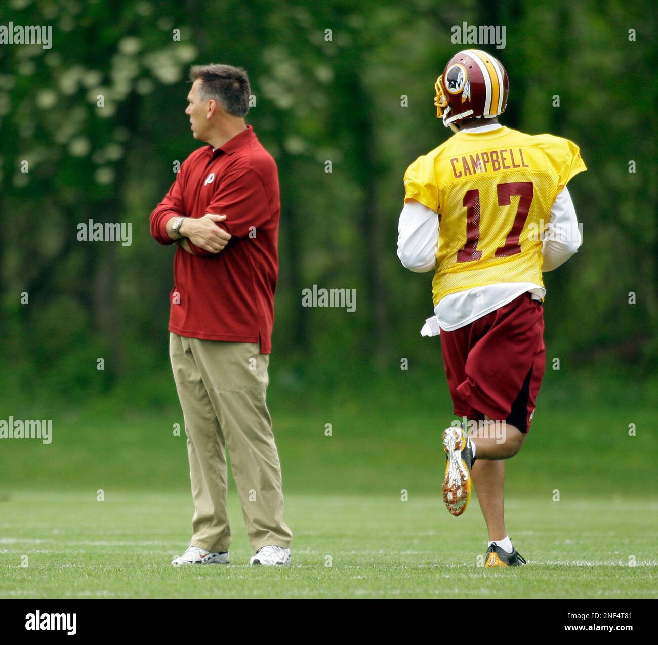 Washington Redskins head coach Jim Zorn stands, as quarterback Jason ...