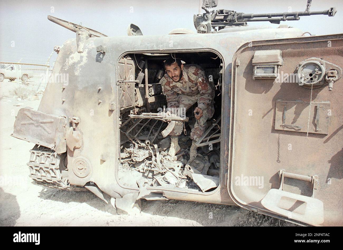 A Saudi soldier emerges from burned out Iraqi BMP-1 armored personnel ...