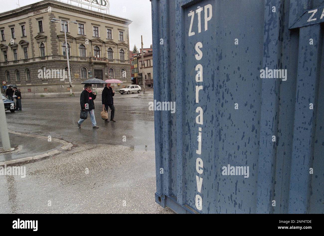 After Sarajevo city government erected overnight an anti-sniper barricade, Sarajevans walk ...
