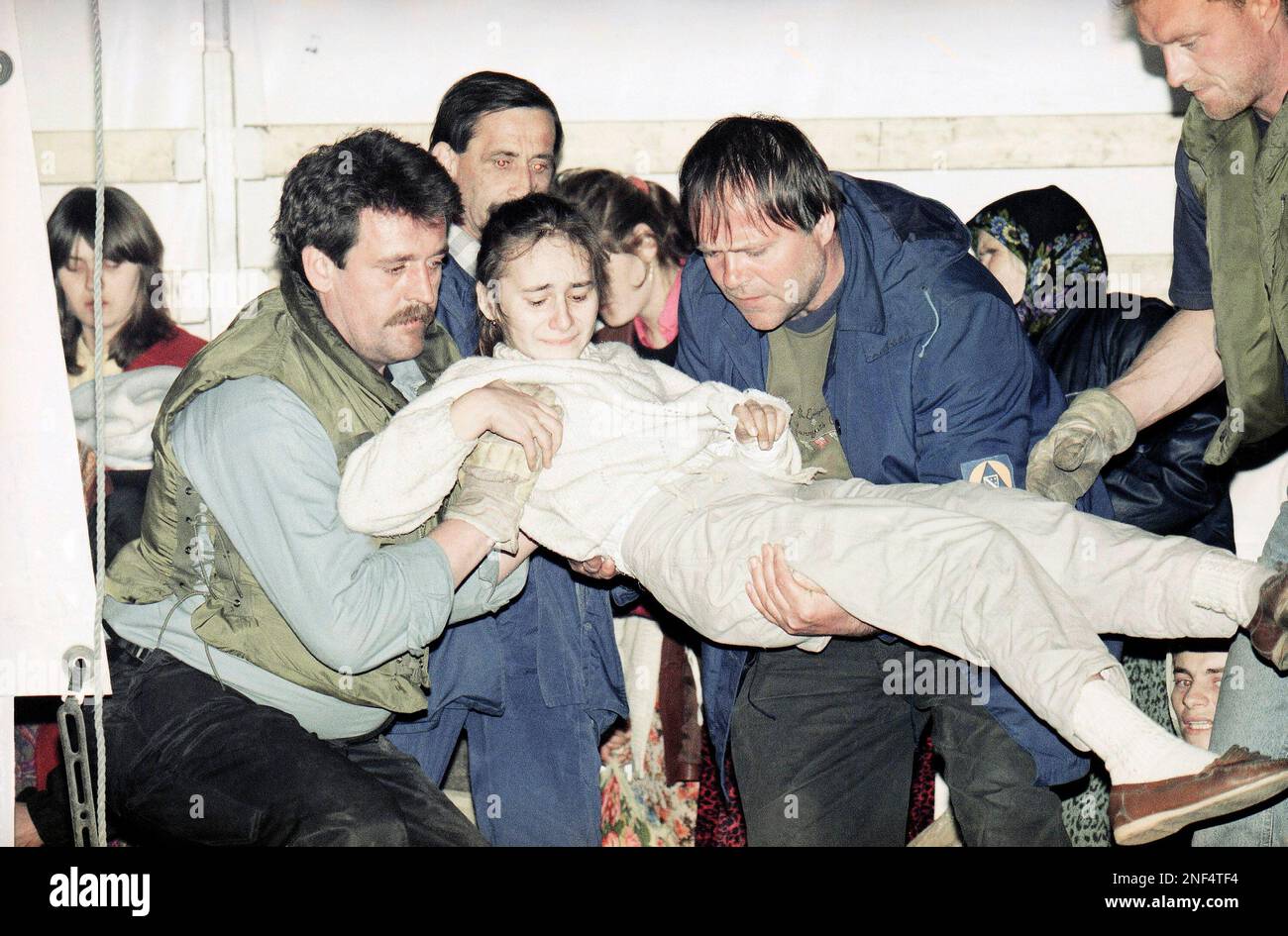 Bosnian volunteers carry a wounded girl from a U.N. truck after ...