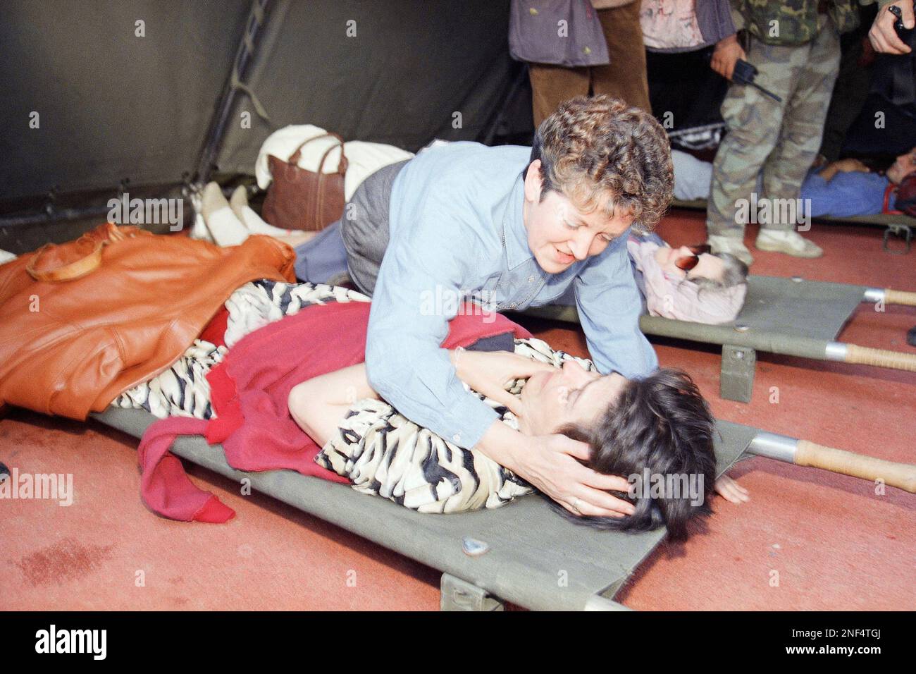 A wounded woman from the Eastern Bosnia Muslim town of Gorazde is ...