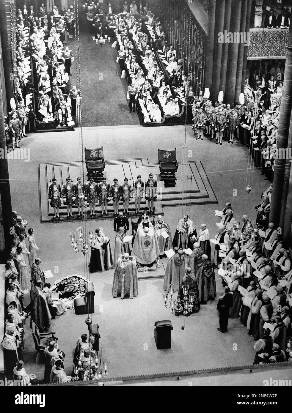 King George VI is shown as he receives the crown during the coronation ...