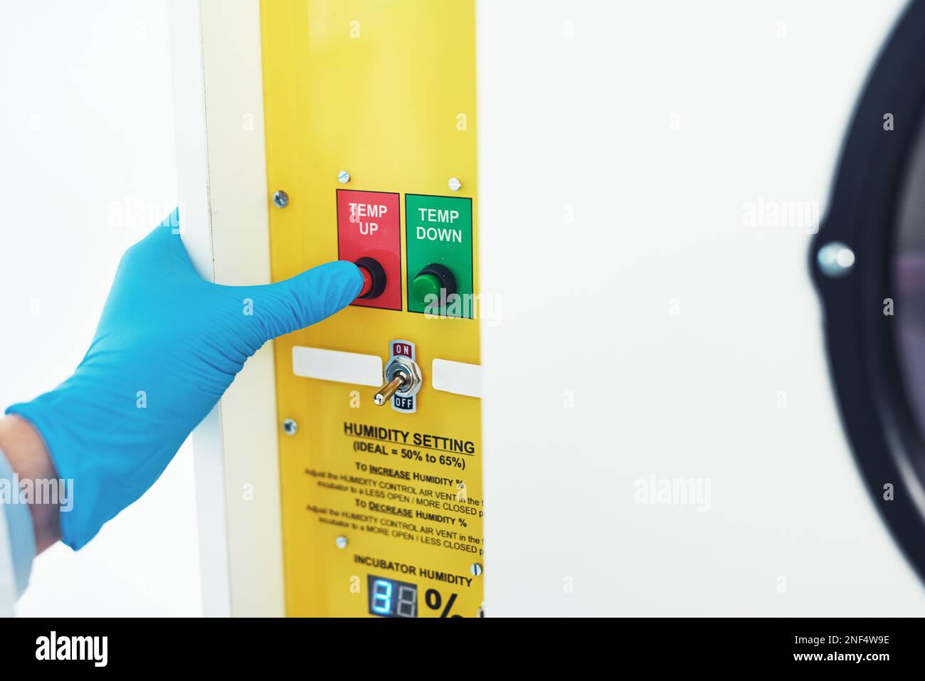 Press to start. Closeup of an unrecognizable scientist wearing surgical ...
