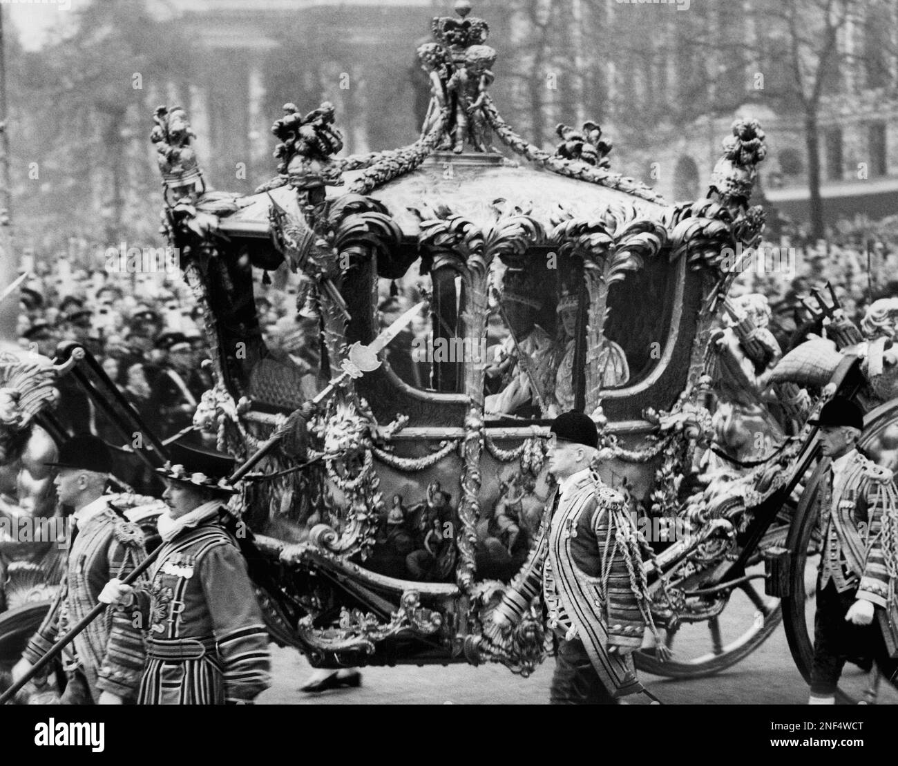 King George VI, wearing the crown of state, and the Queen Elizabeth ...