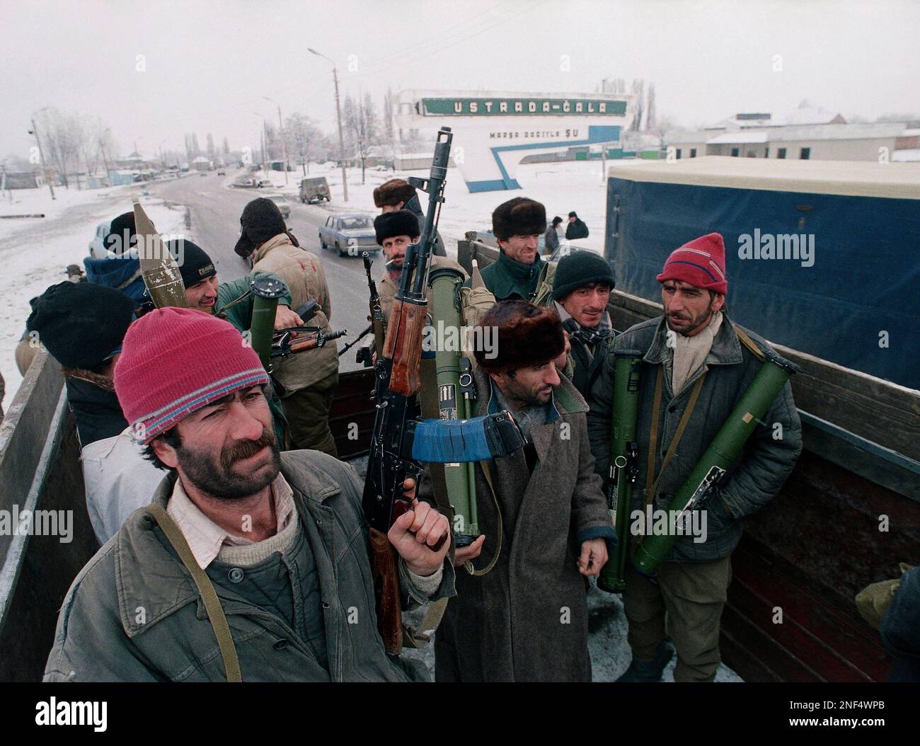 Chechen volunteer fighters ride in a truck on an icy road near the town ...