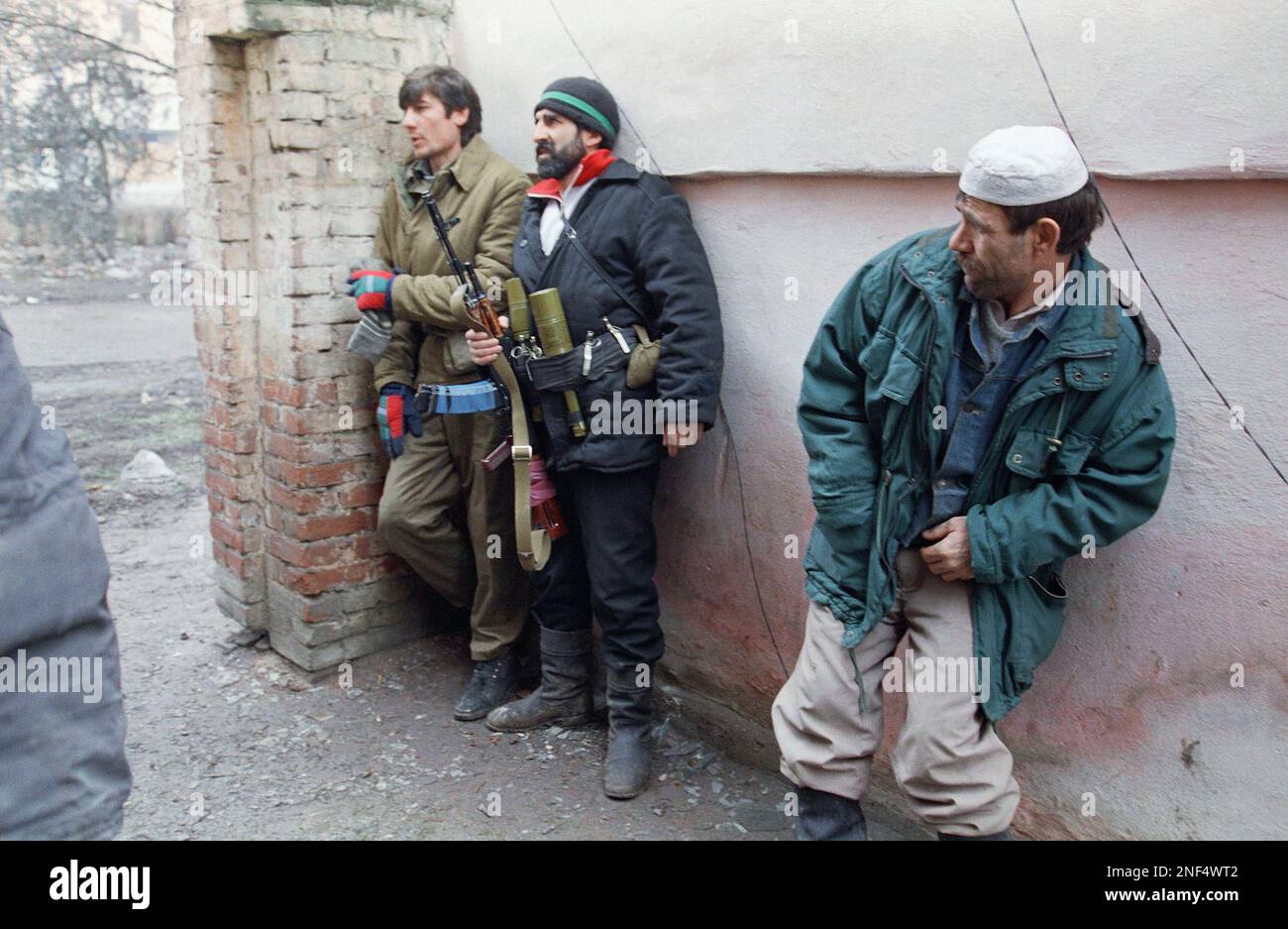 Three Chechen fighters take cover in Grozny, Russia on Thursday, Jan ...