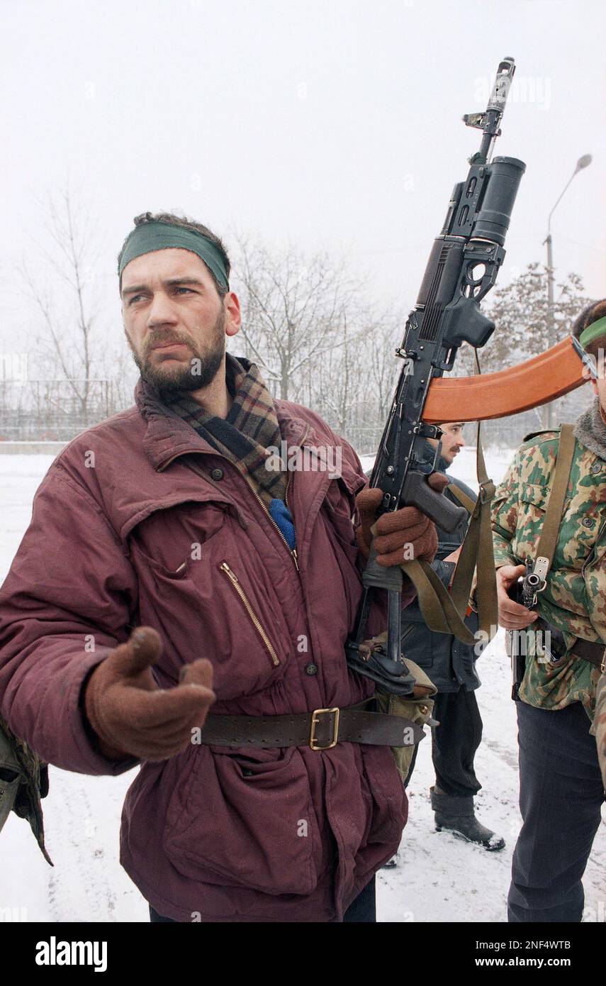 A Chechen fighter shows off his new weapon in Grozny, Russia on ...