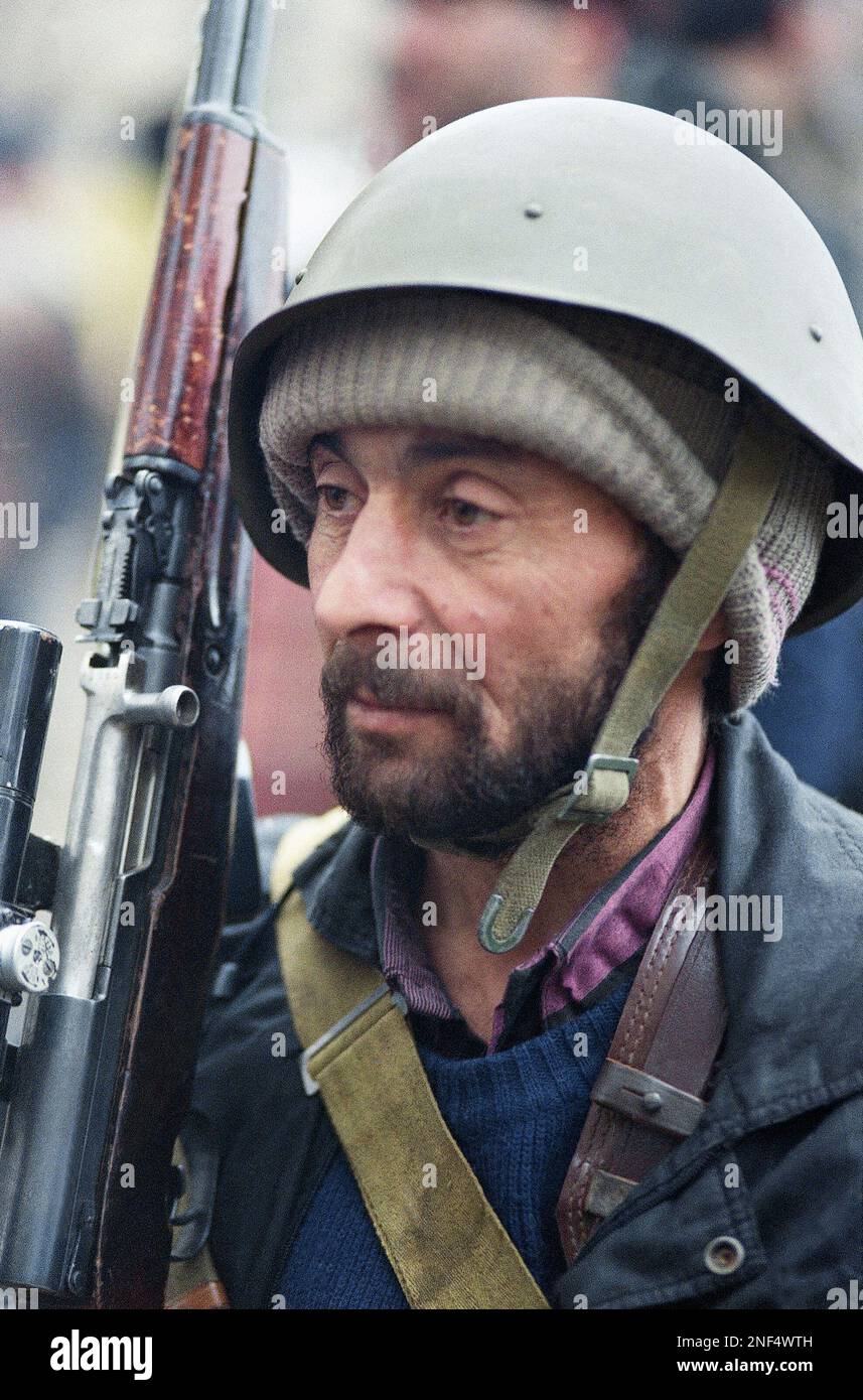 A weary-looking Chechen fighter takes a moment alone after having come ...
