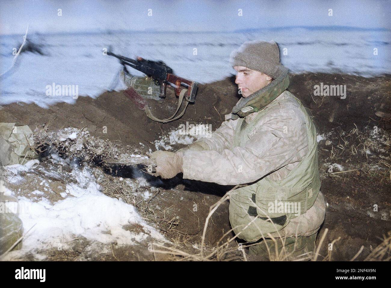 A Russian soldier digs a foxhole while setting up a defensive position ...