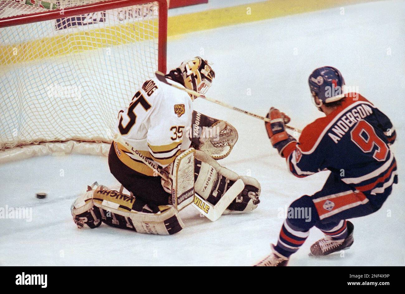 Glenn Anderson of the Edmonton Oiler's, right, sends a shot past Boston ...