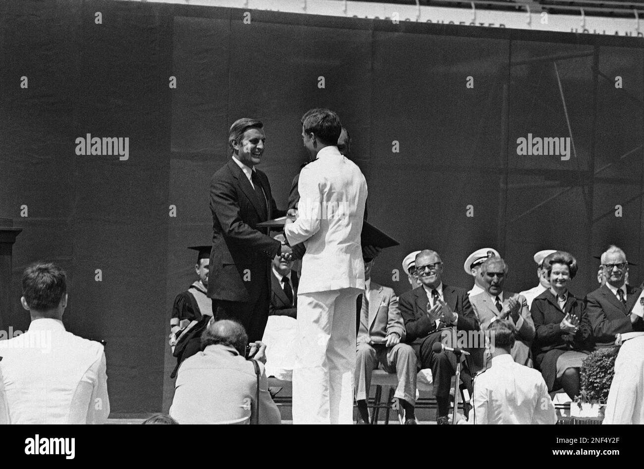 U.S. Vice President Walter Mondale hands the first diploma at the U.S ...