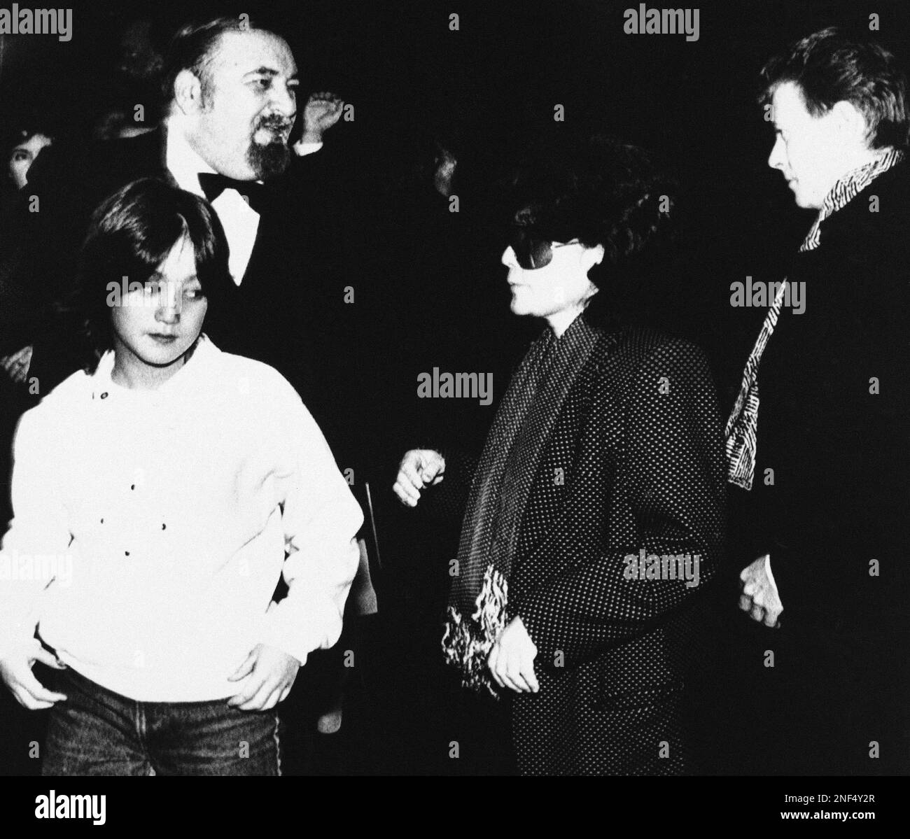 Sean Lennon, left and his mother, Yoko Ono, accompanied by David Bowie ...